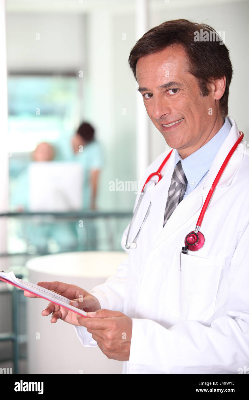 Doctor checking clip-board Stock Photo - Alamy