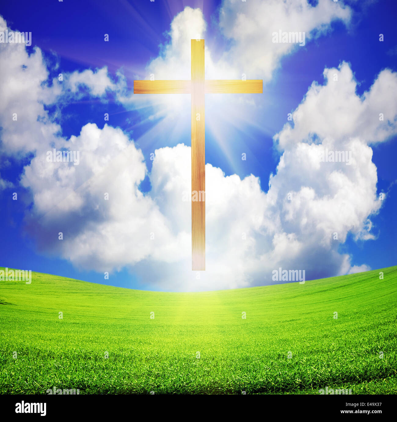 easter cross over green field and blue sky Stock Photo - Alamy