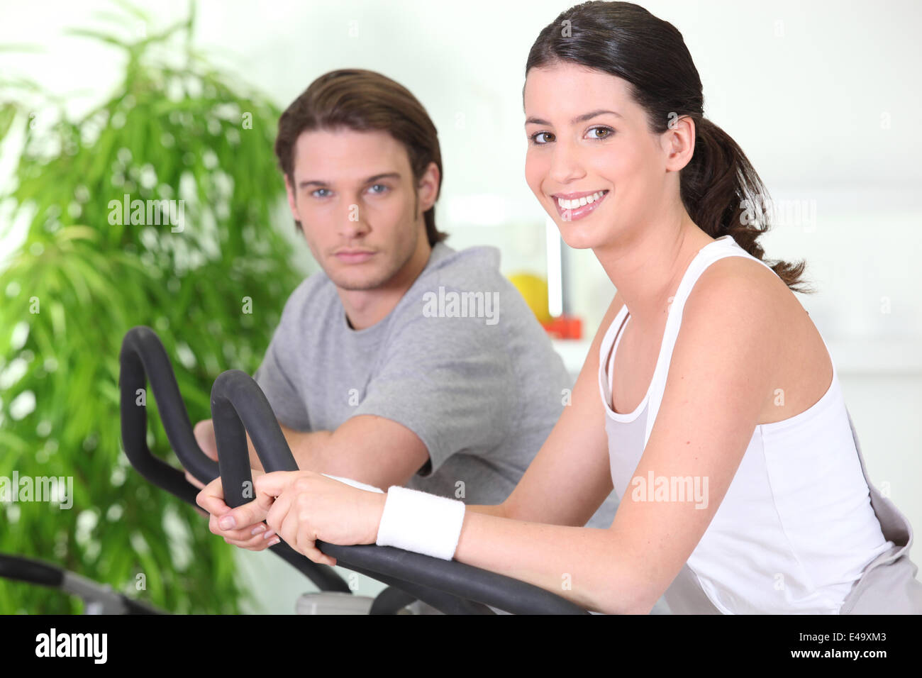 Couple working out together in the gym Stock Photo - Alamy