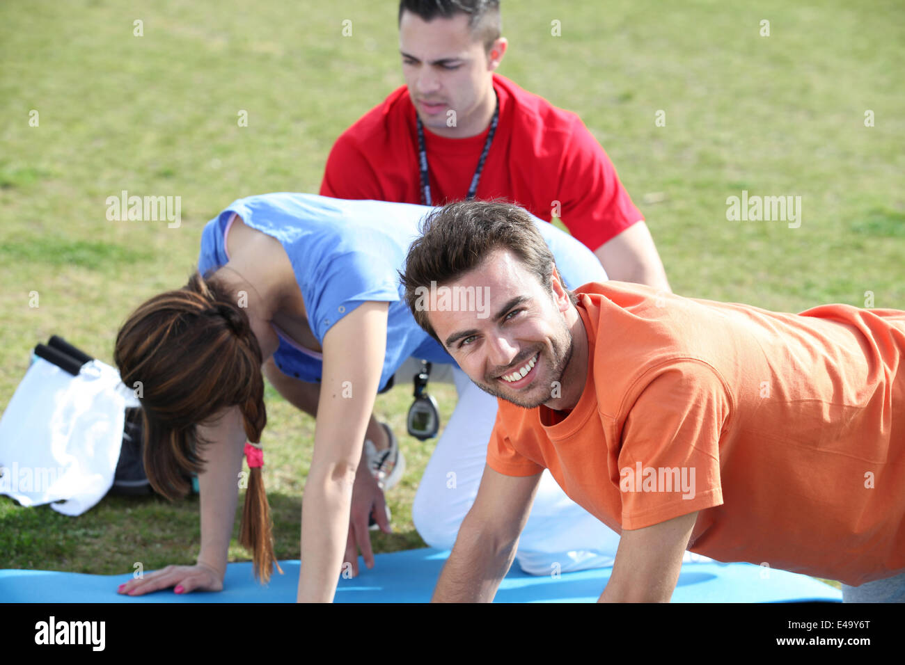 Young people doing press ups in the park Stock Photo - Alamy