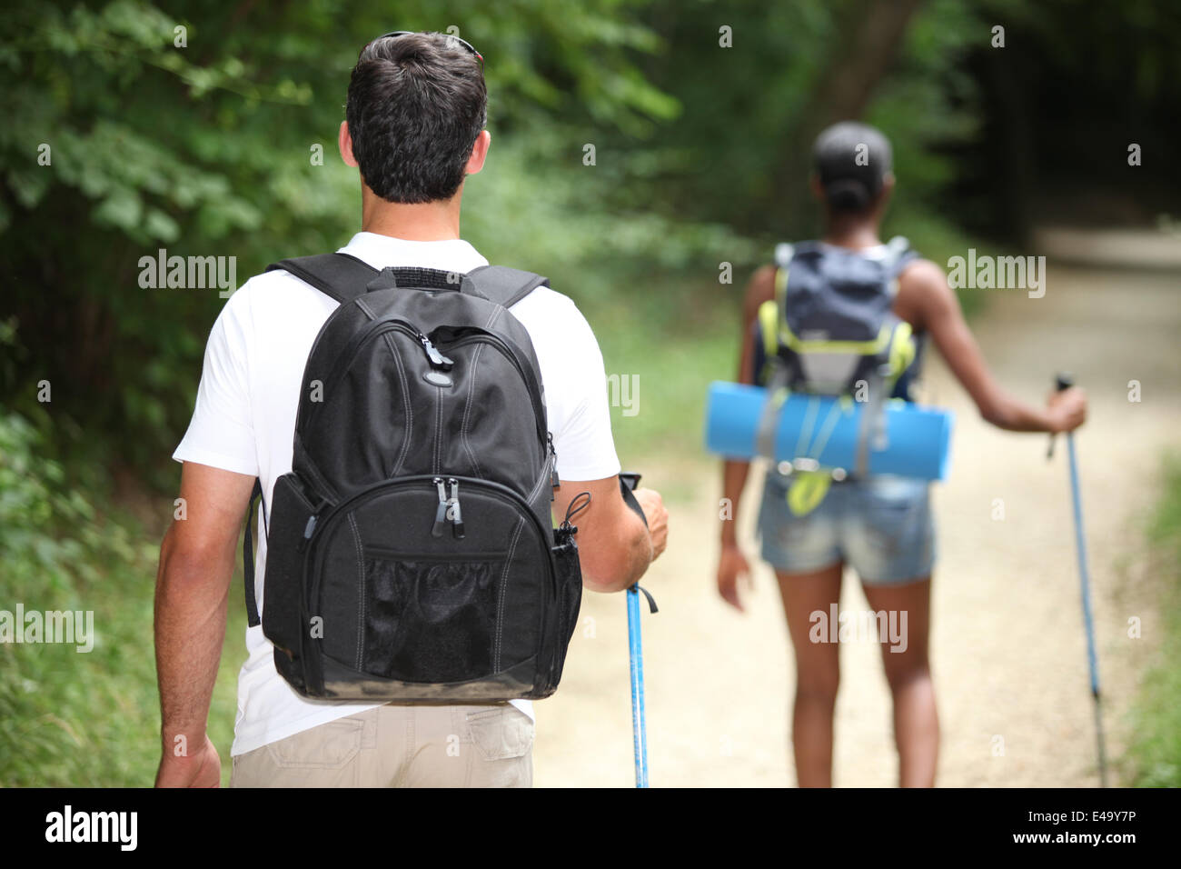 Young couple walking through countryside Stock Photo - Alamy