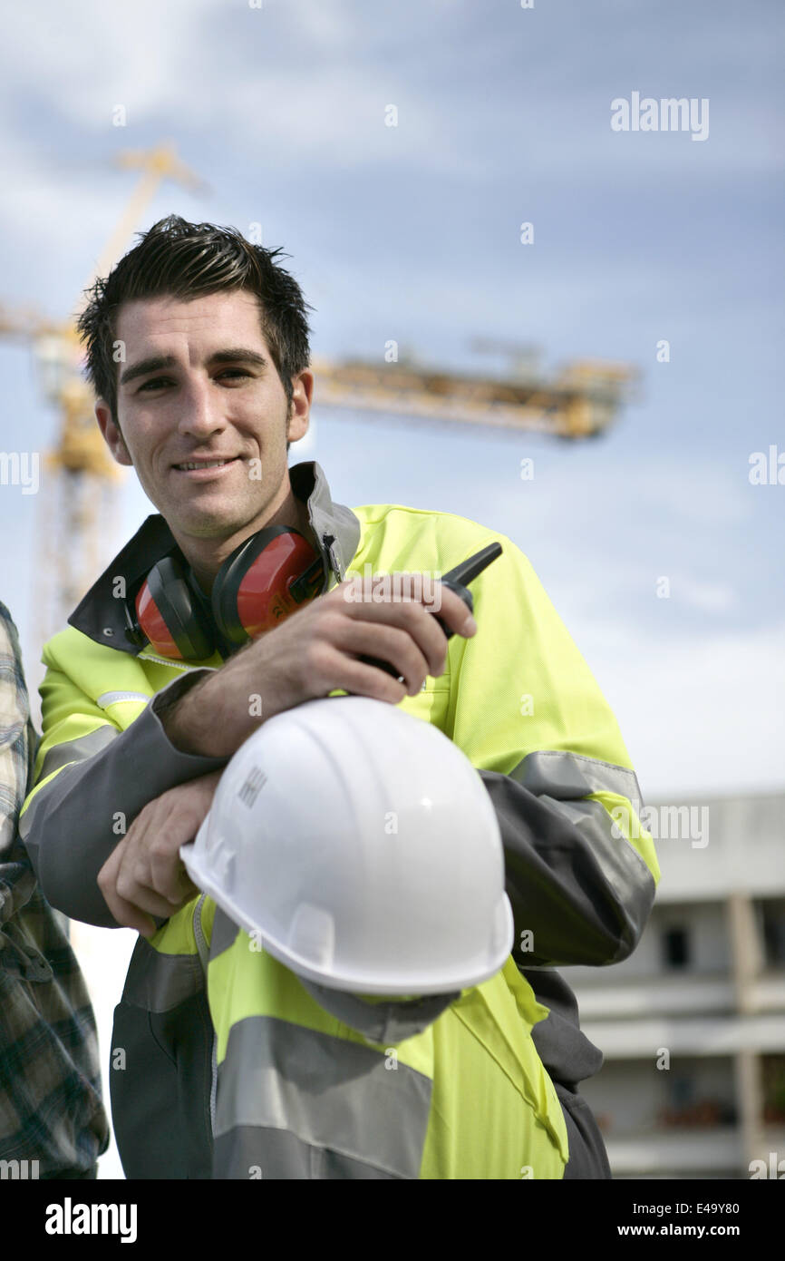 Smiling workman on a construction site Stock Photo - Alamy