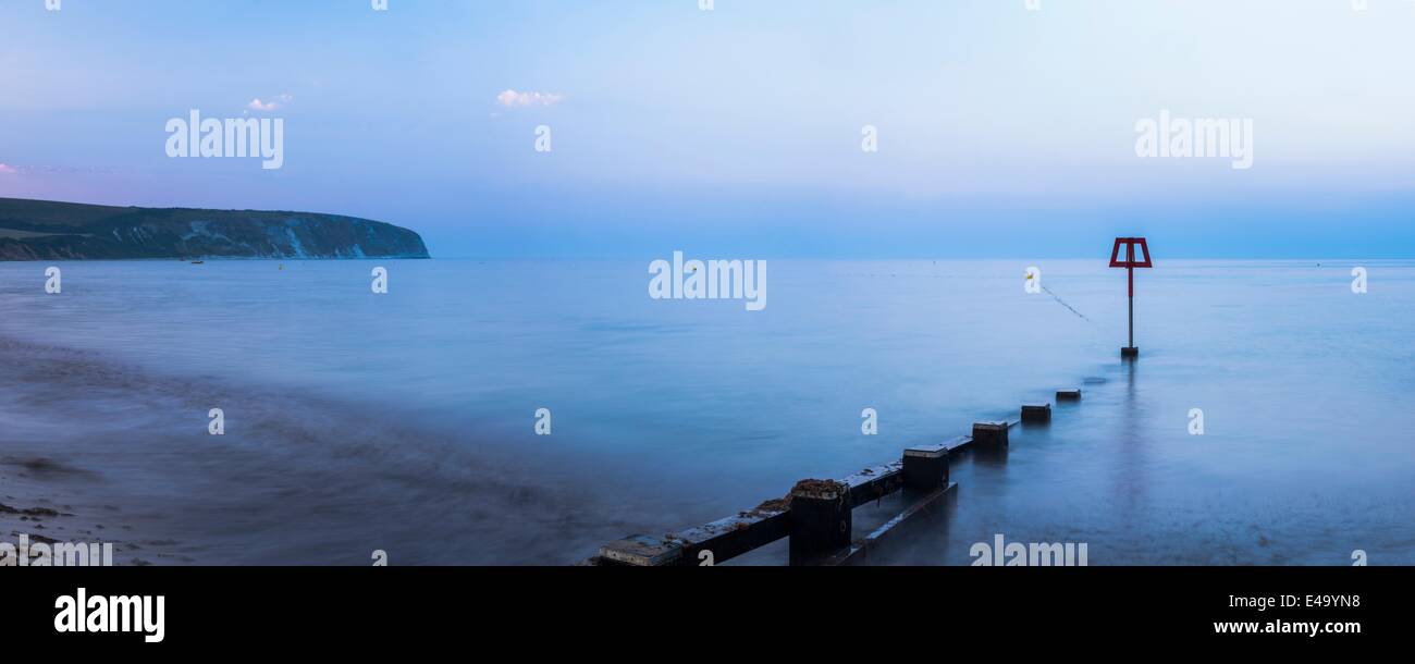 Cliffs and wave break at Swanage Beach at sunset, Dorset, England ...