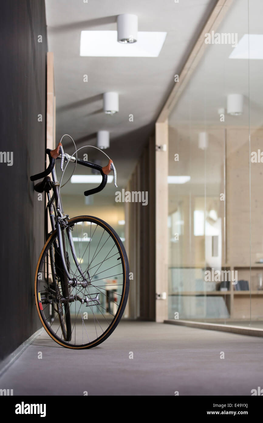 Racing cycle standing in corridor of modern office Stock Photo - Alamy