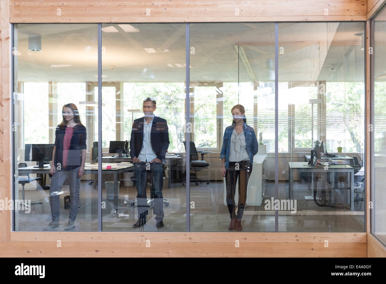 Team of three business people at workplace in modern office Stock Photo ...