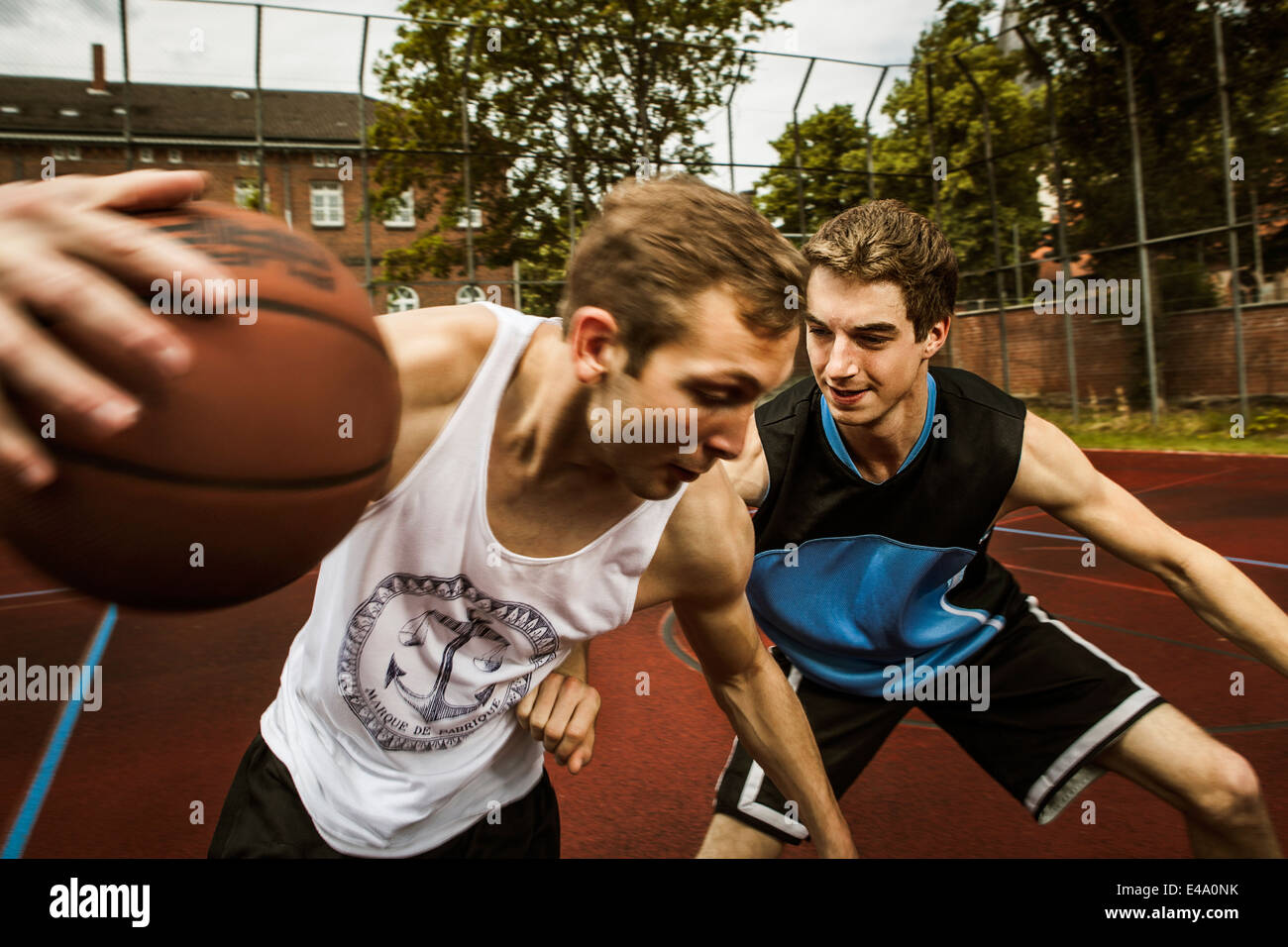 Two young basketball players at duel Stock Photo - Alamy