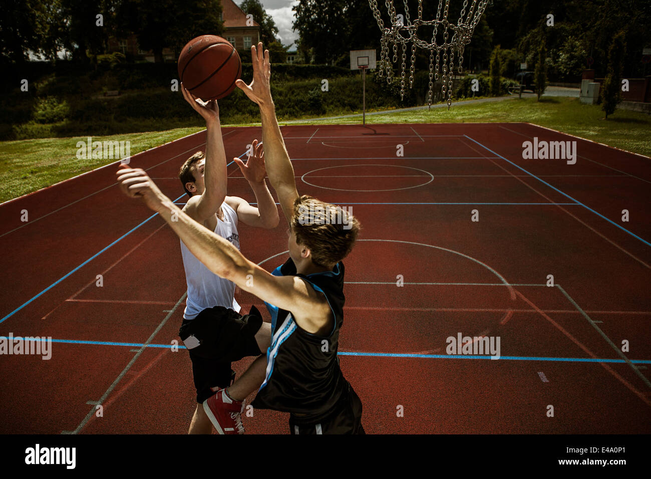 Two young basketball players at duel Stock Photo - Alamy