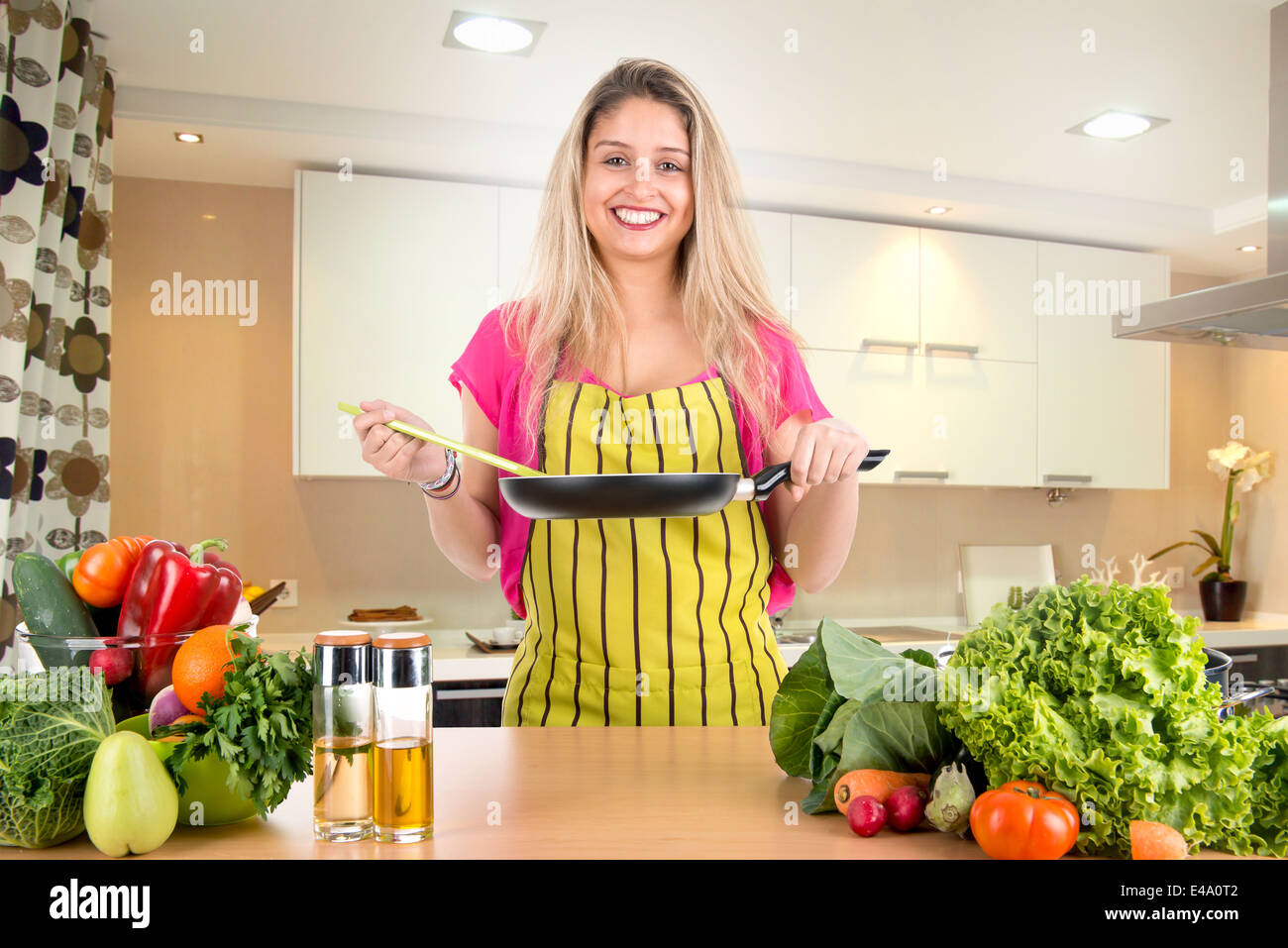 Beautiful woman cooking in the kitchen Stock Photo - Alamy