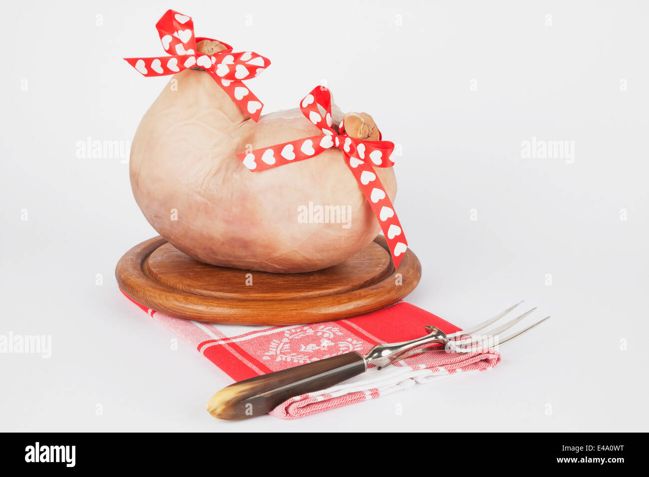 Palatine stuffed pig's stomach on chopping board Stock Photo - Alamy