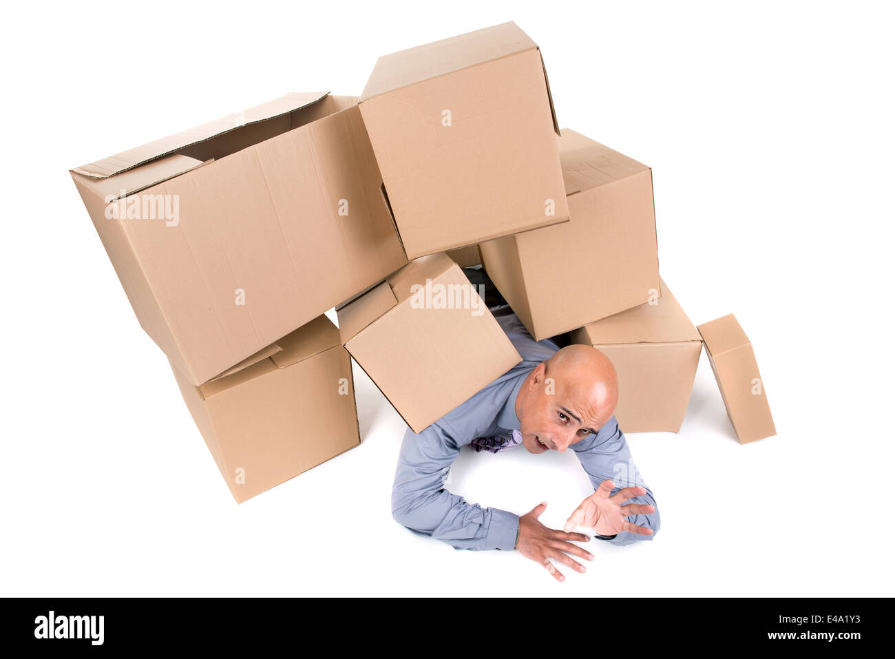 Stressed businessman under a pile of cardboard boxes Stock Photo - Alamy