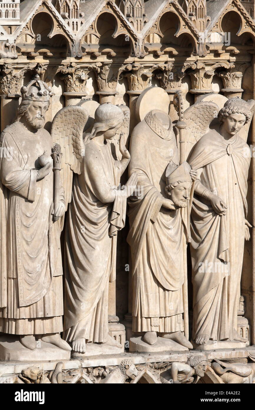 St. Denis holding his head flanked by two angels, Virgin portal ...