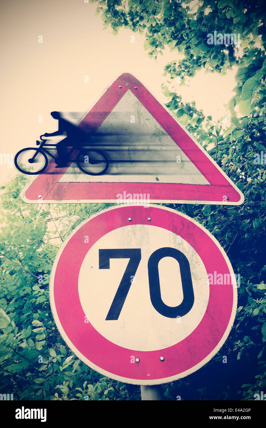 Germany, Road signs, Biker coming out of warning sign Stock Photo - Alamy