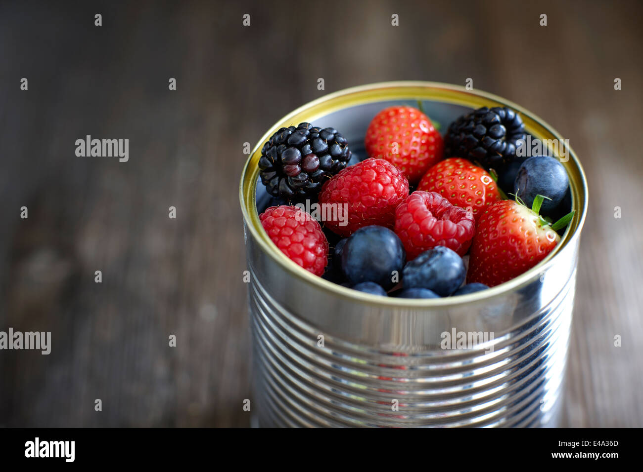 Berries in tin can Stock Photo - Alamy