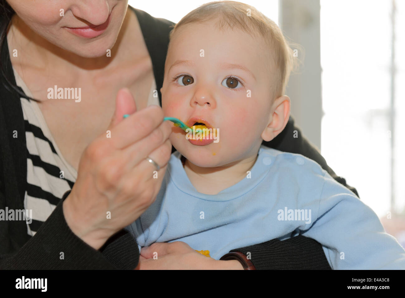Mother feeding baby boy Stock Photo - Alamy