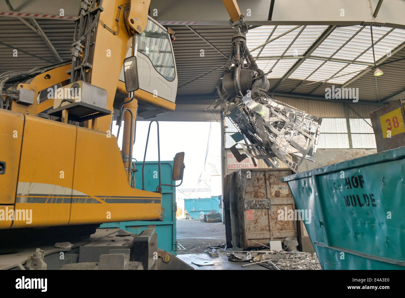 Excavator in a scrap metal recycling plant Stock Photo - Alamy
