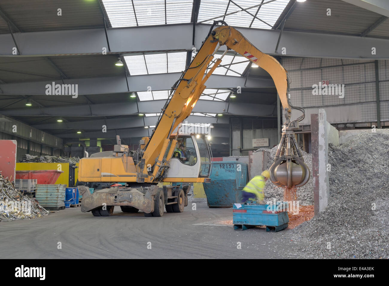 Excavator in a scrap metal recycling plant Stock Photo - Alamy