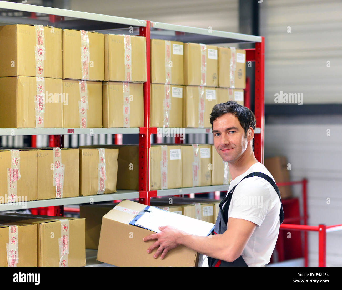 Portrait of smiling worker in warehouse Stock Photo - Alamy