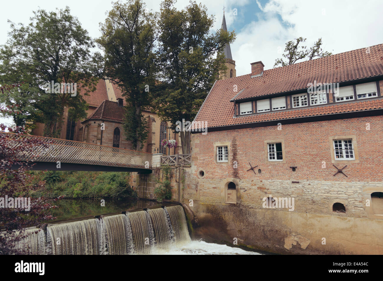 Germany, North Rhine-Westphalia, Telgte, Dam at mill and Saint Clemens ...