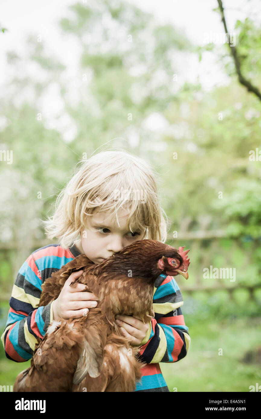 Portrait of little boy with chicken Stock Photo - Alamy