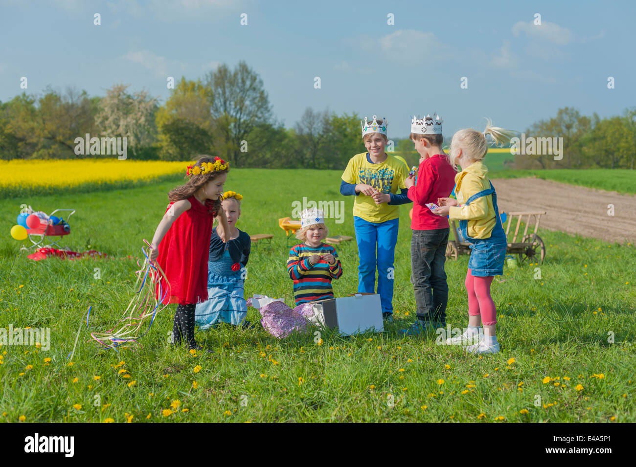 Group of children playing on a meadow Stock Photo - Alamy