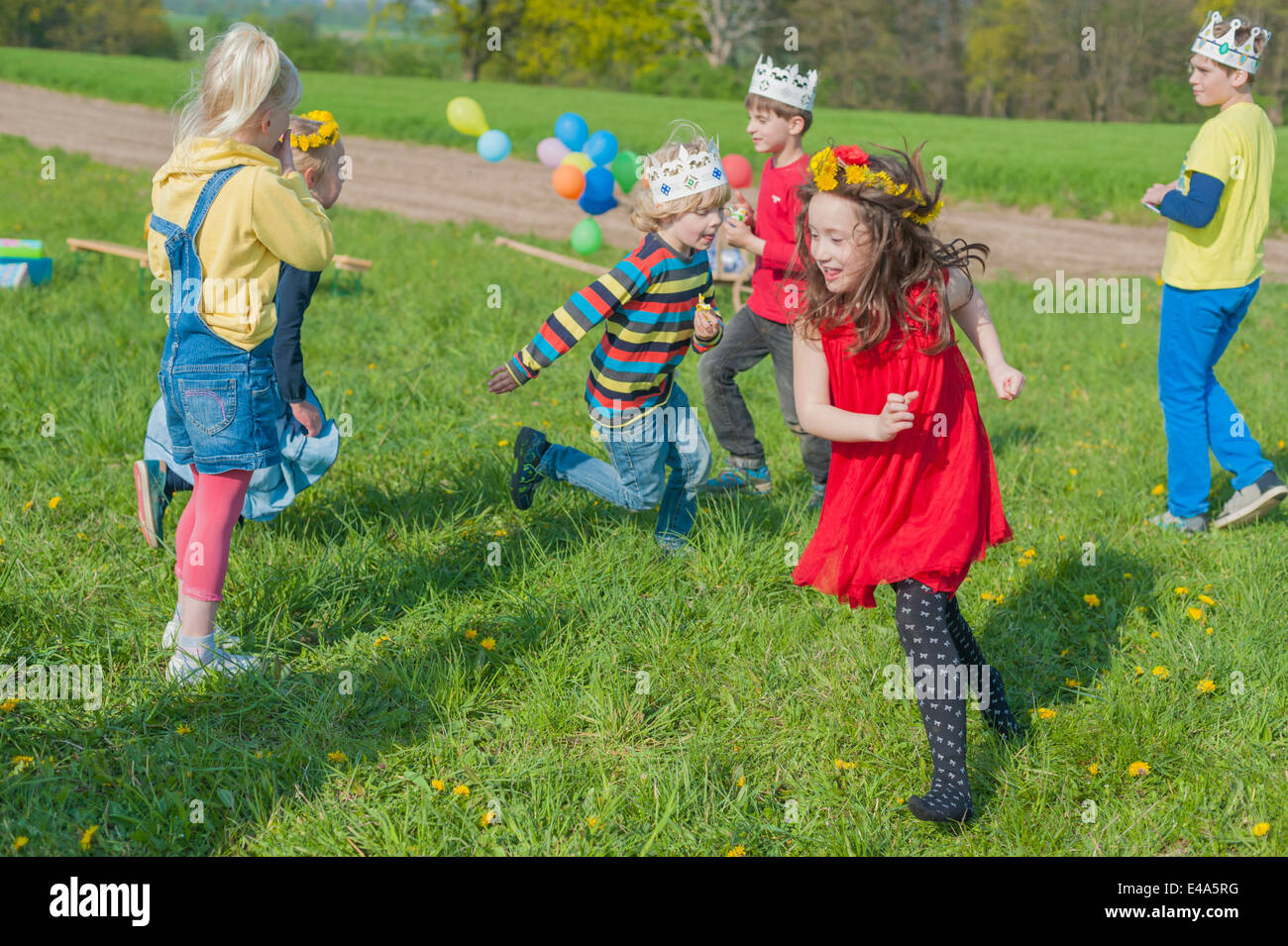 Group of children playing on a meadow Stock Photo - Alamy