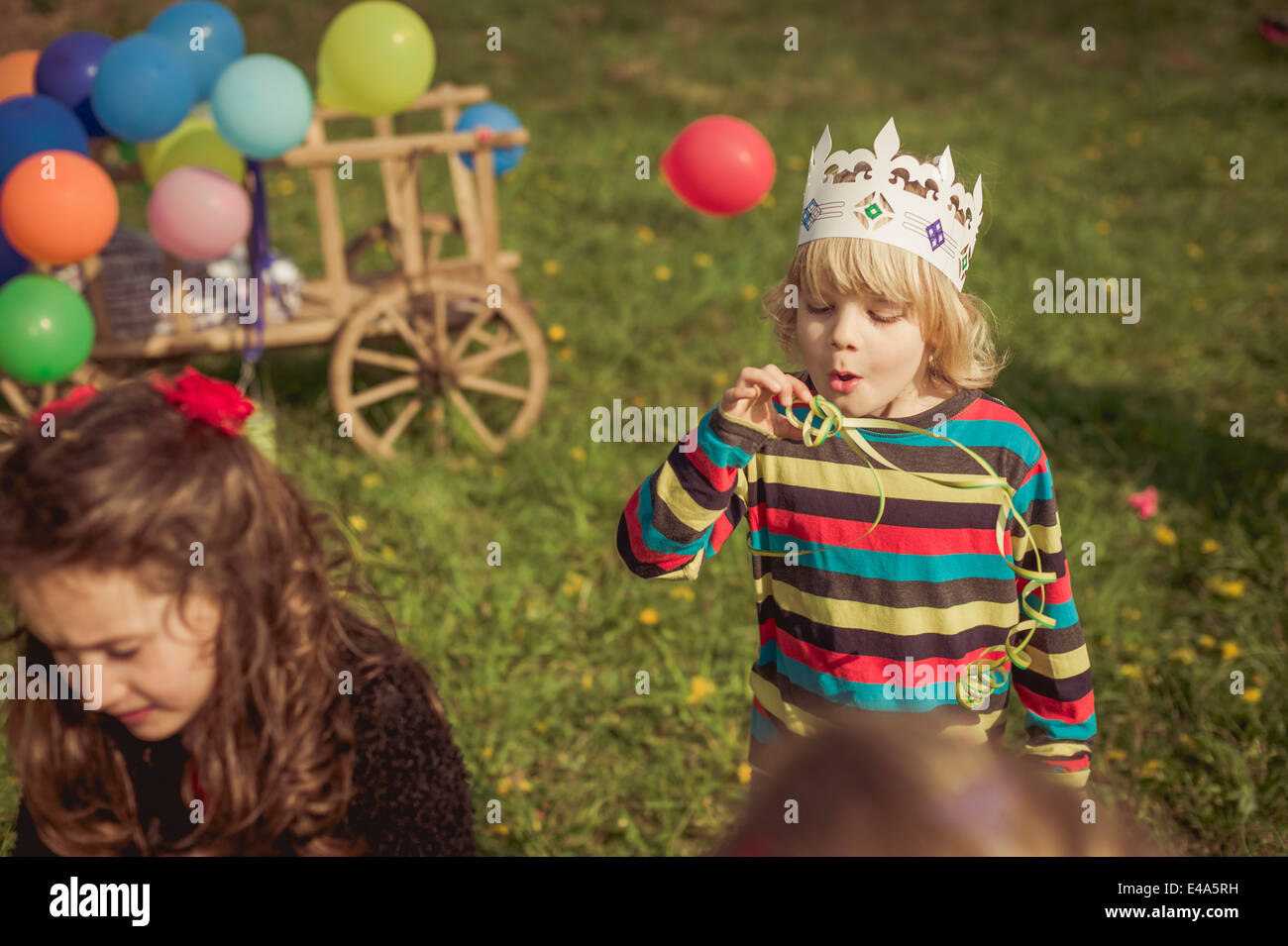 Little boy blowing streamer Stock Photo - Alamy