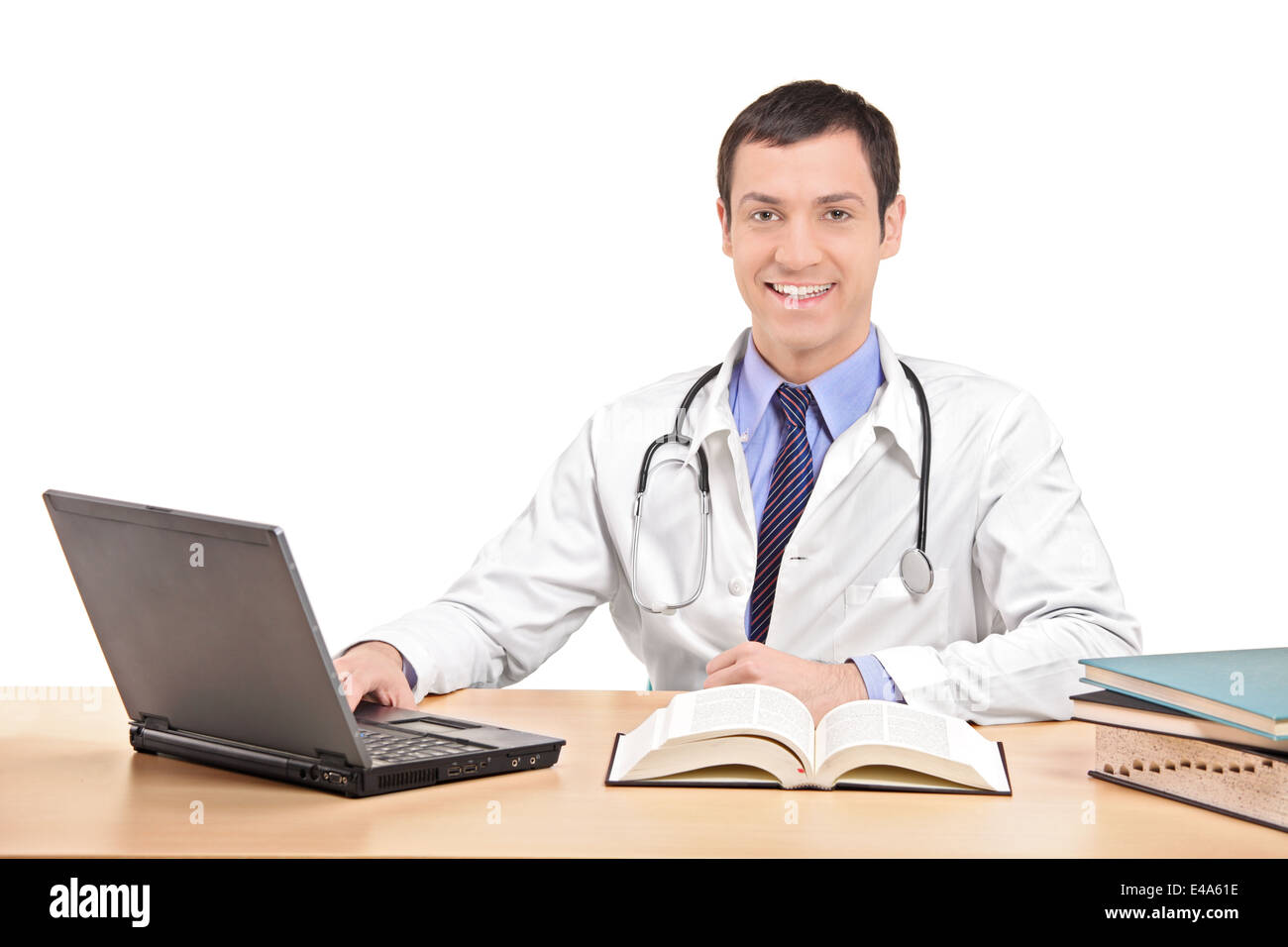 Doctor sitting at a desk and working on laptop Stock Photo - Alamy