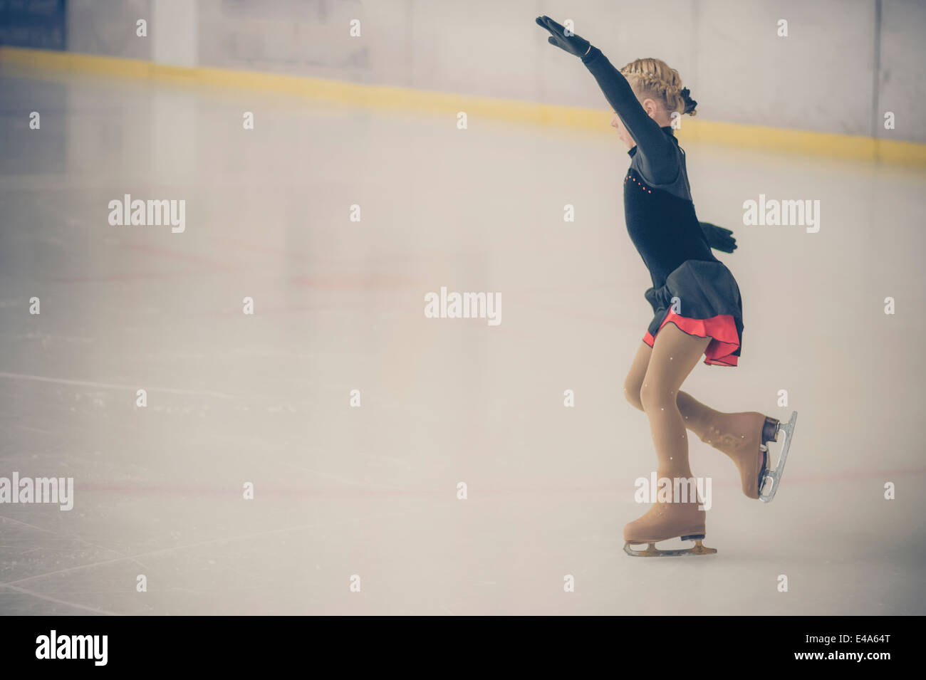 Young female figure skater moving on ice rink at competition Stock ...