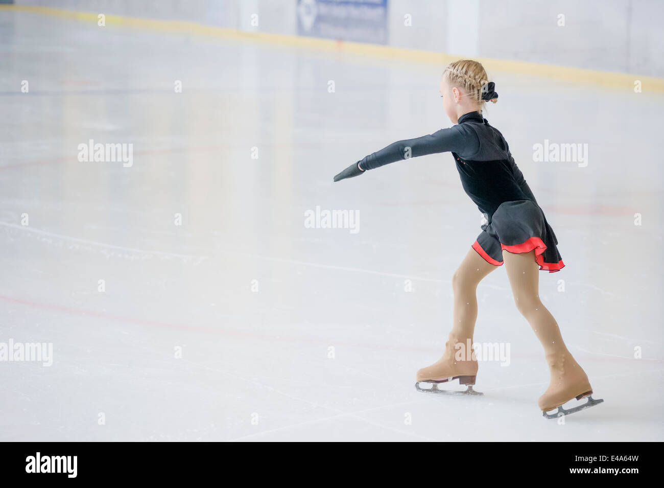 Young female figure skater moving on ice rink at competition Stock ...
