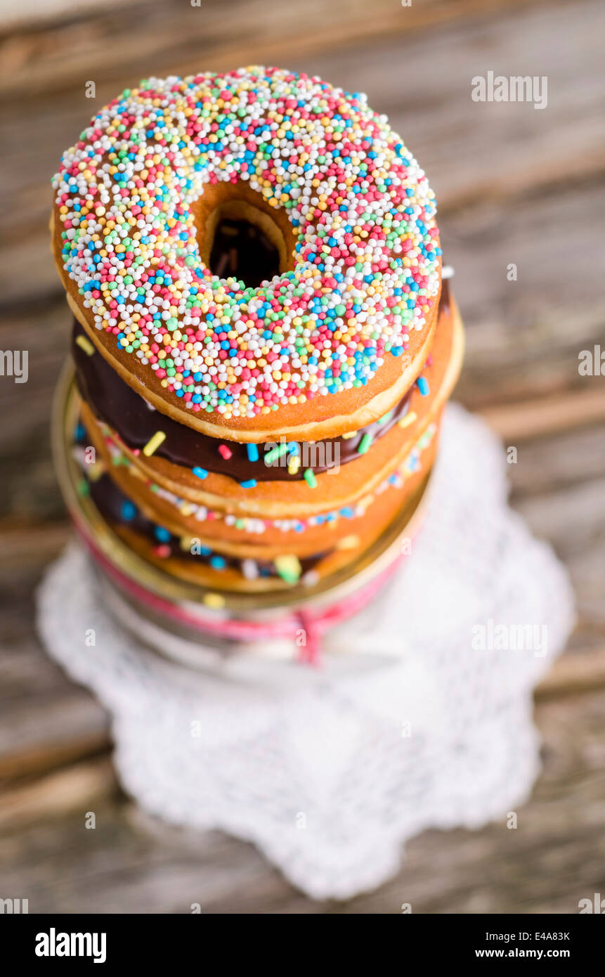 Stack of three doughnuts decorated with sugar granules, elevated view ...