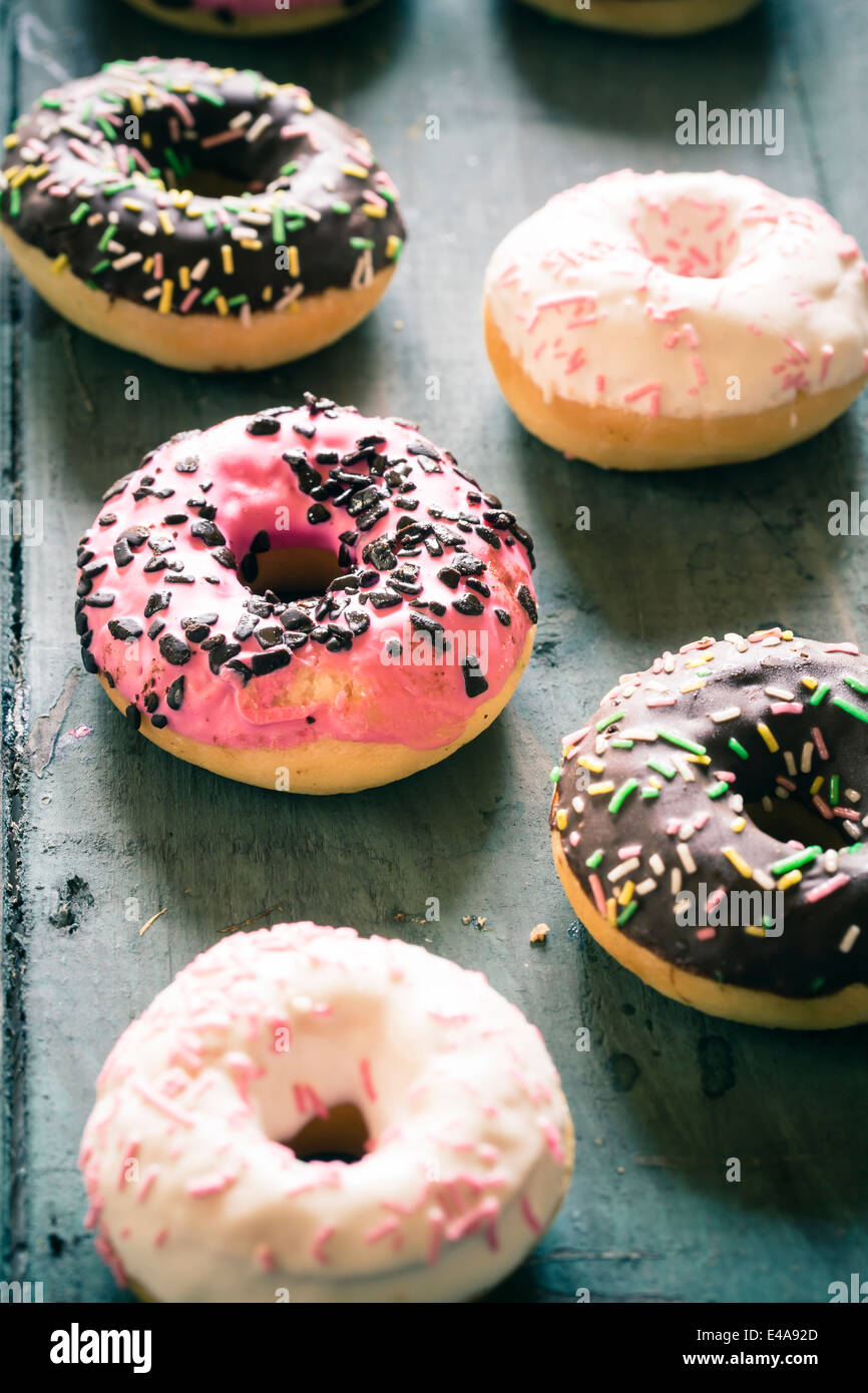 Five mini doughnuts on wooden table Stock Photo - Alamy