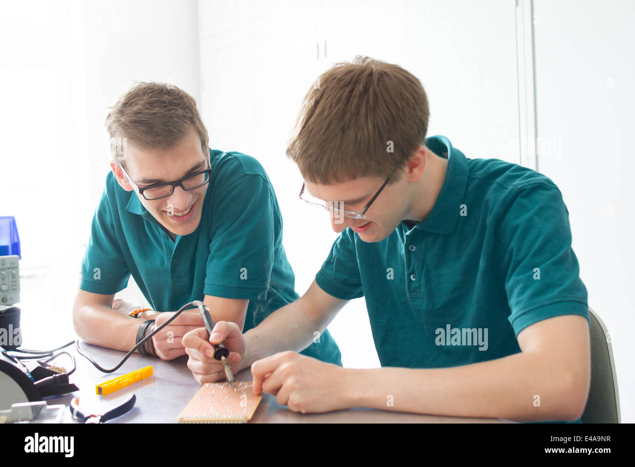 Electronic apprentice soldering circuit board at workshop Stock Photo ...