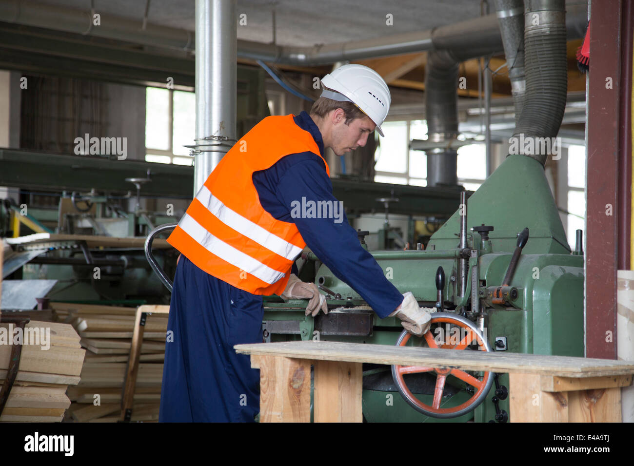 Young worker at carpentry of pallet production Stock Photo - Alamy