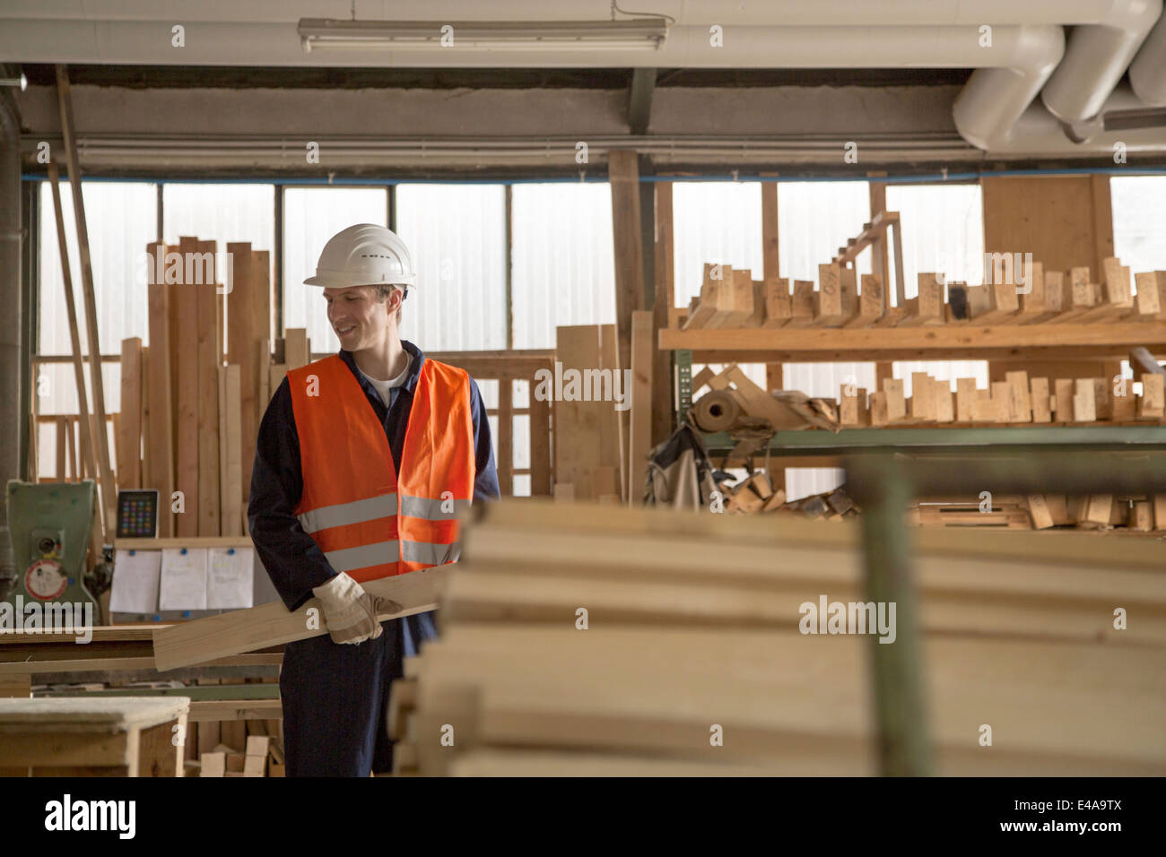 Young worker at carpentry of pallet production Stock Photo - Alamy