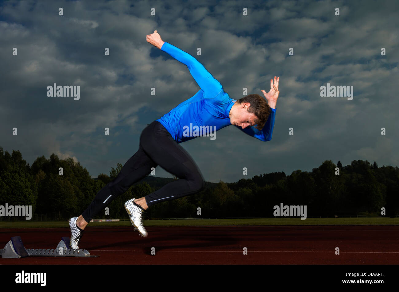 Sprinter starting, side view Stock Photo - Alamy
