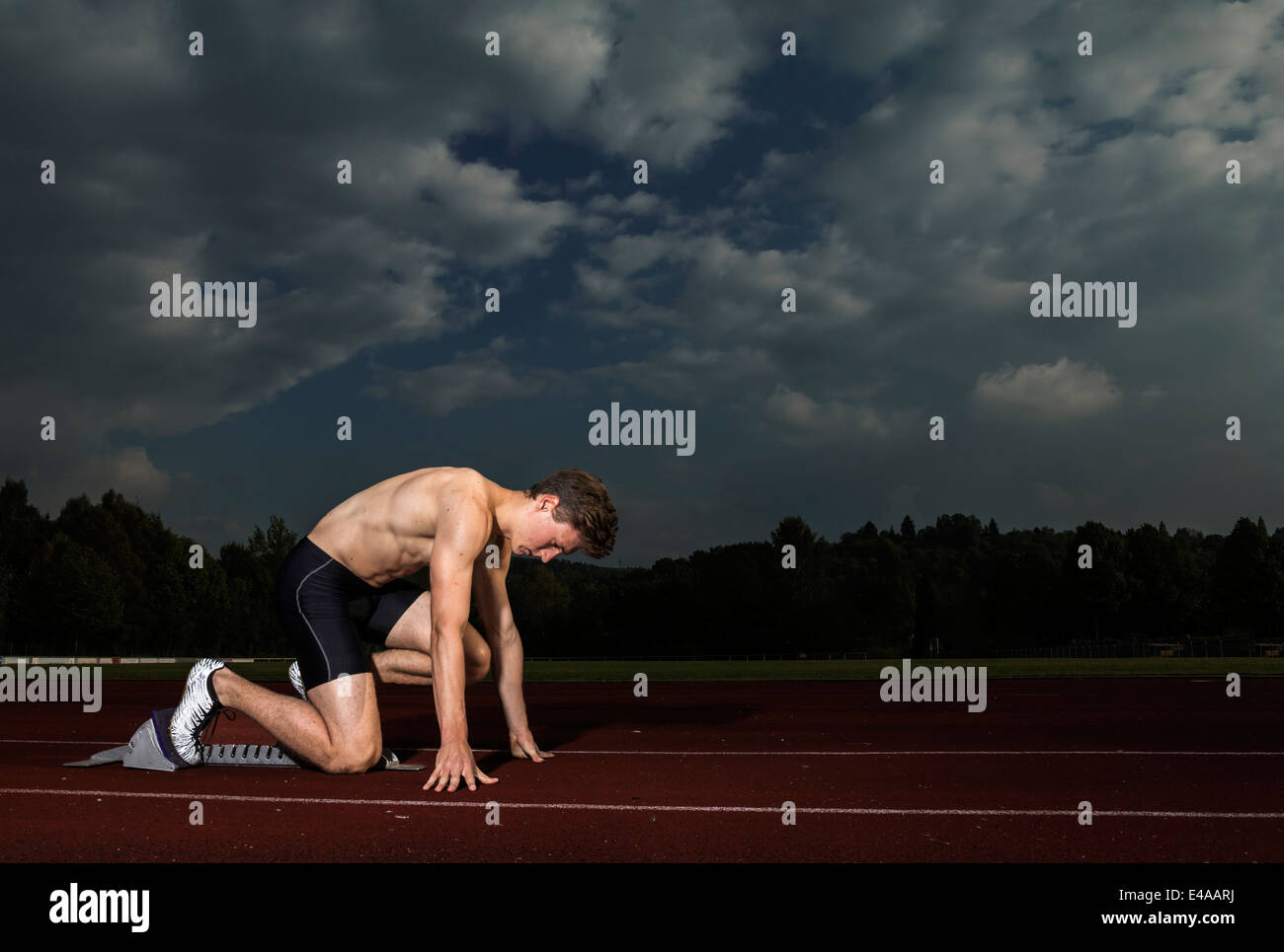 Sprinter starting, side view Stock Photo - Alamy