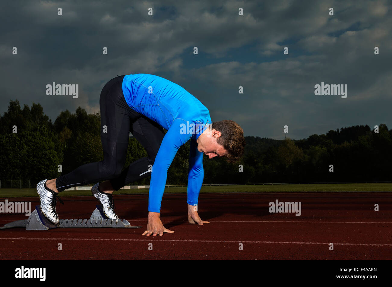 Sprinter starting, side view Stock Photo - Alamy