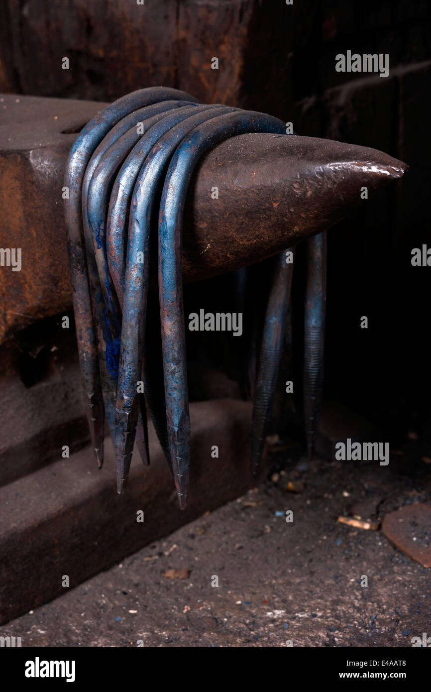 Germany, Bavaria, Josefsthal, blue metal hooks hanging on anvil beak at ...