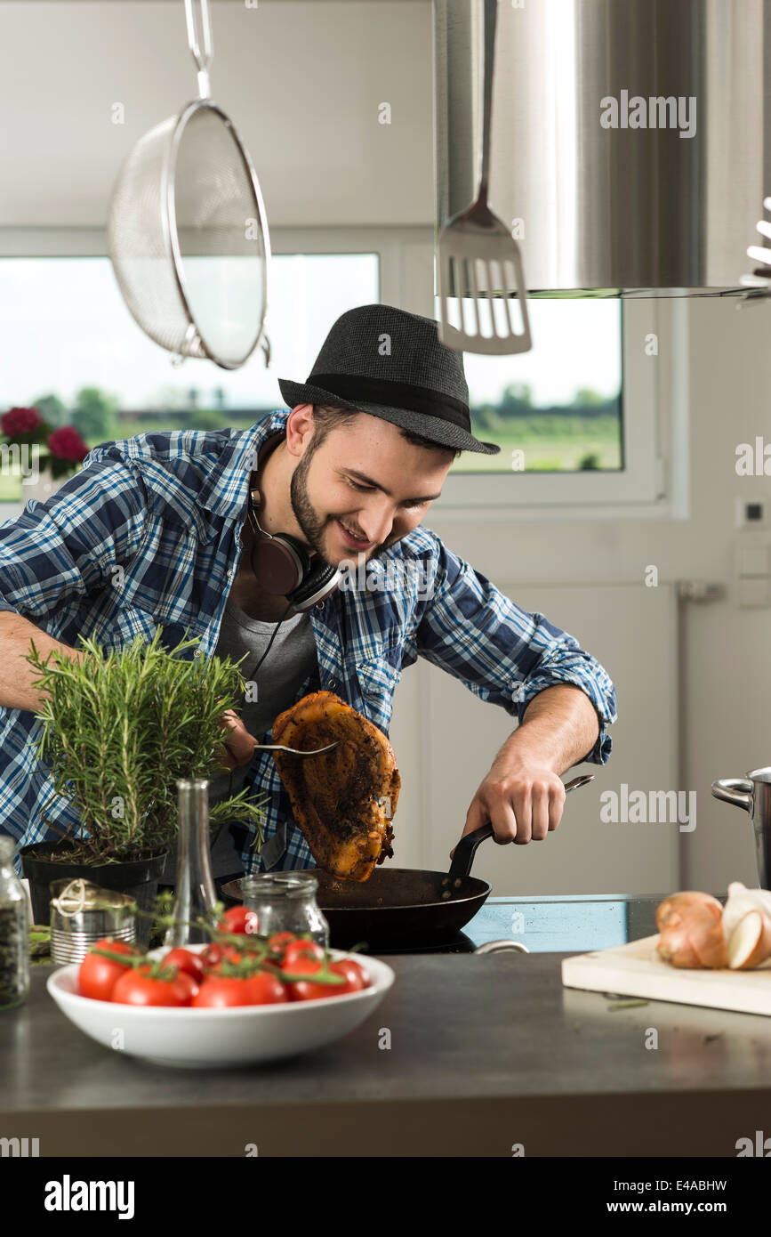 Young man cooking in kitchen at home Stock Photo - Alamy