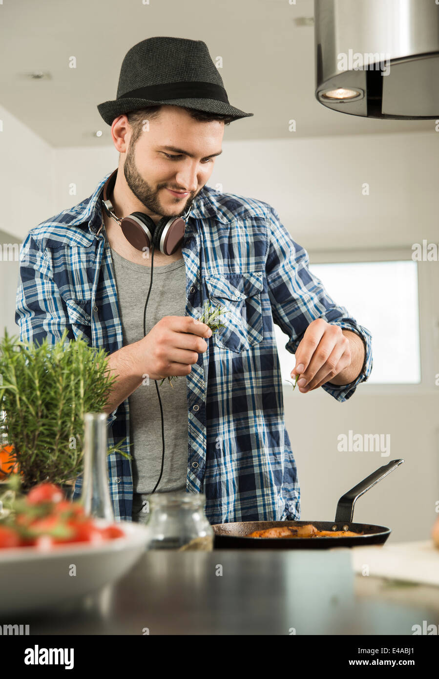 Young man cooking in kitchen at home Stock Photo - Alamy