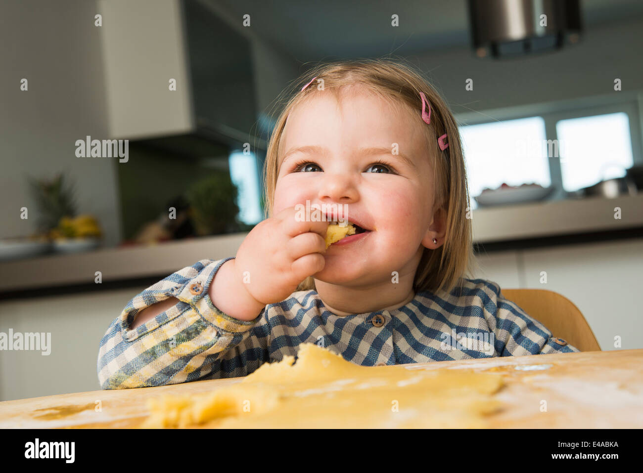 Toddler baking in kitchen Stock Photo - Alamy