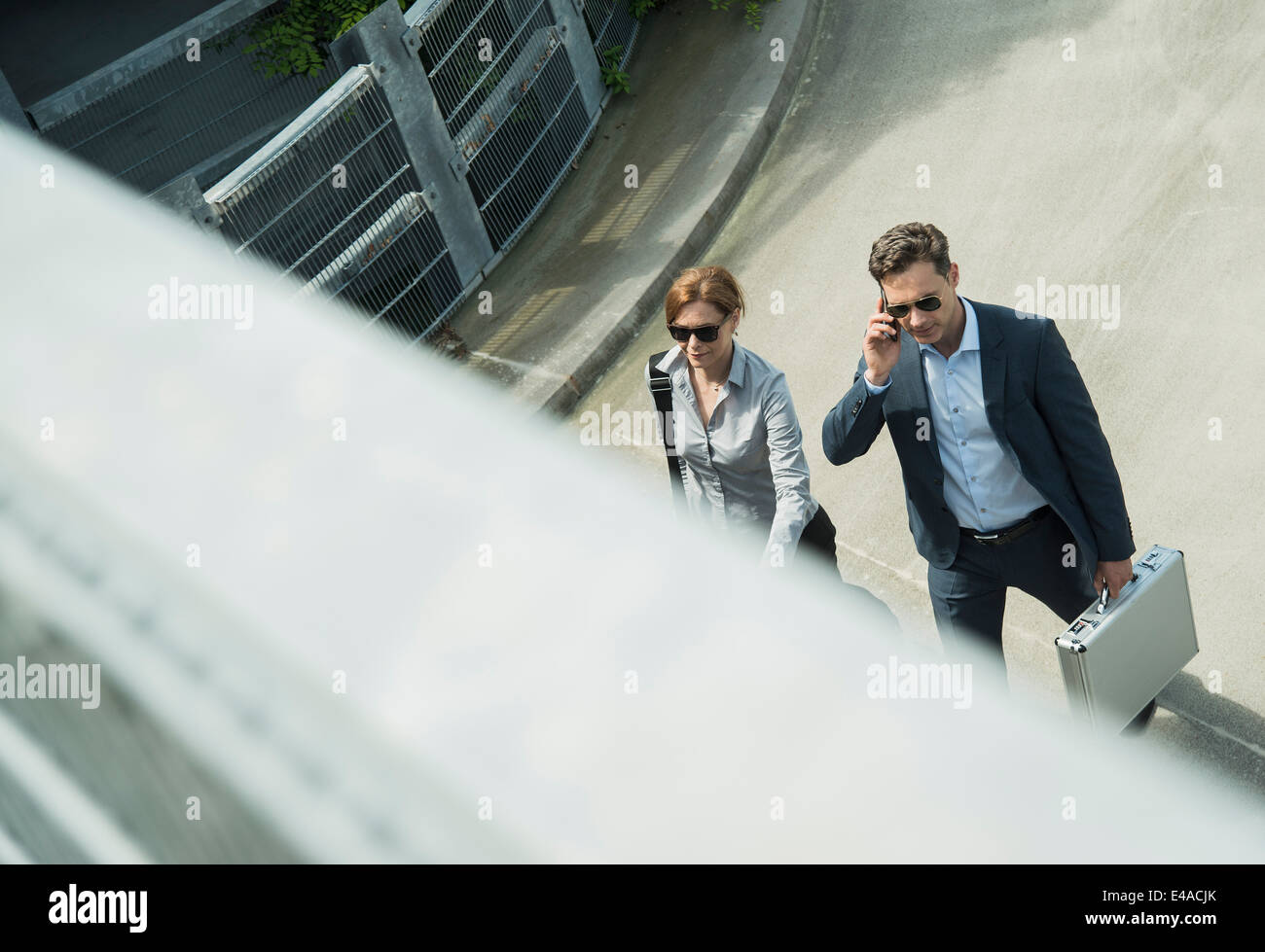 Two business people walking side by side, elevated view Stock Photo - Alamy
