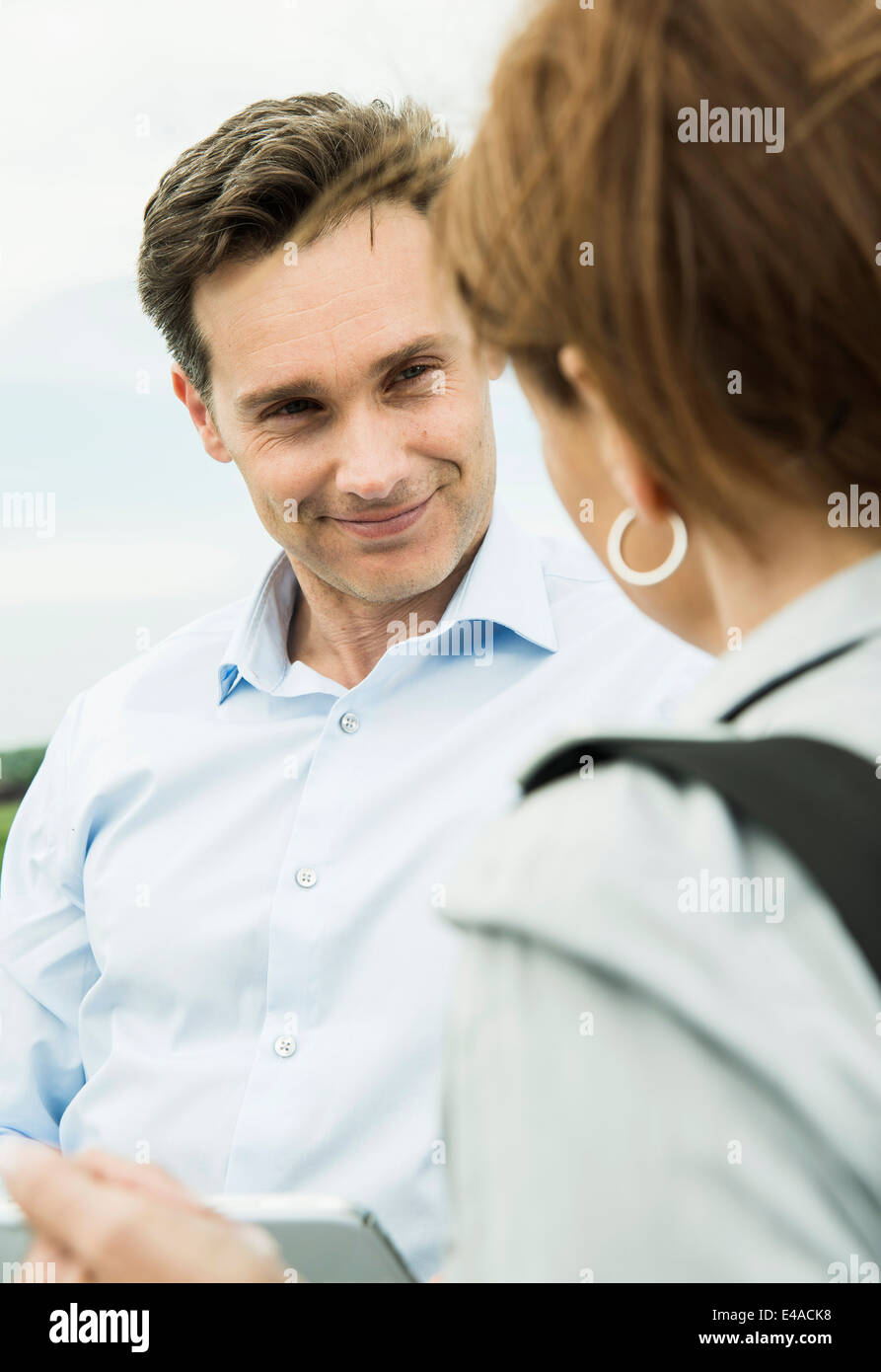 Two business people communicating Stock Photo - Alamy
