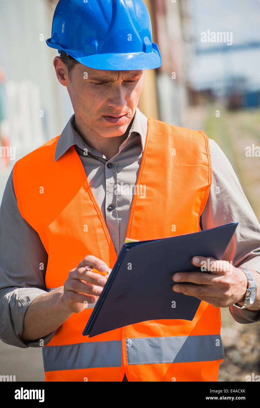 Portrait of man with blue safety helmet checking cargo containers Stock ...