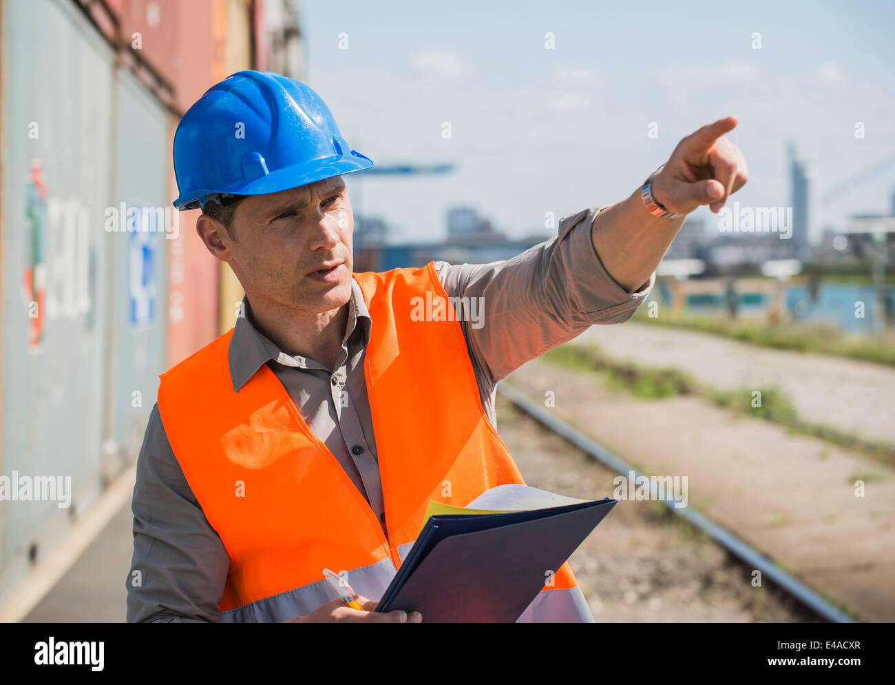 Portrait of man with blue safety helmet checking cargo containers Stock ...