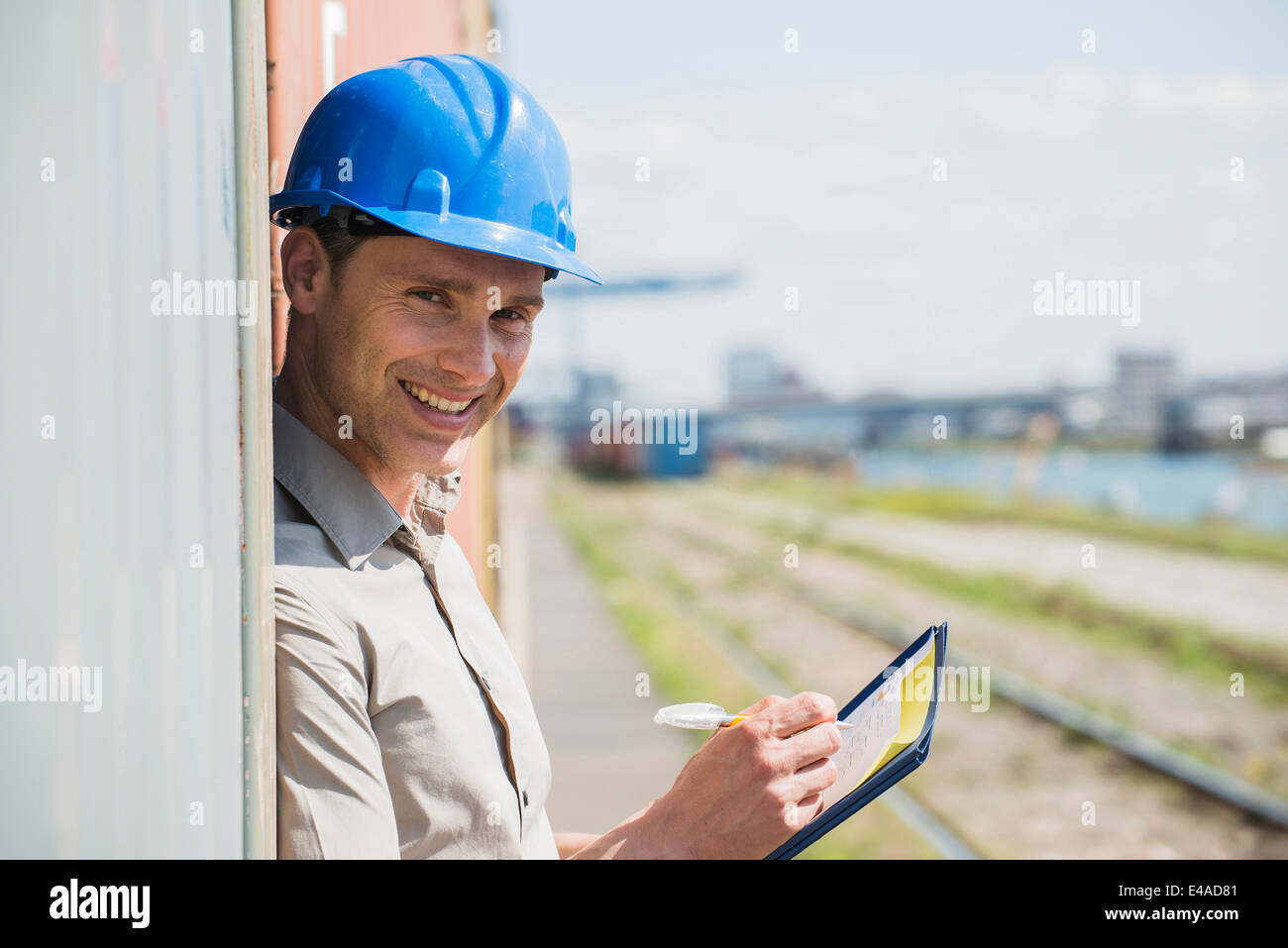 Portrait of man with blue safety helmet checking cargo containers Stock ...