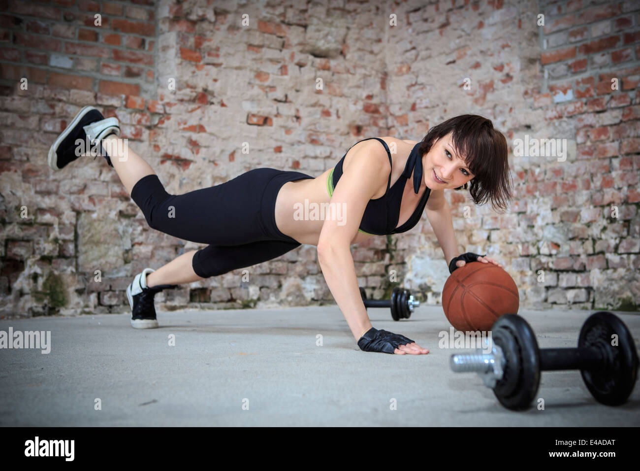 Young woman doing workouts in a gym Stock Photo - Alamy