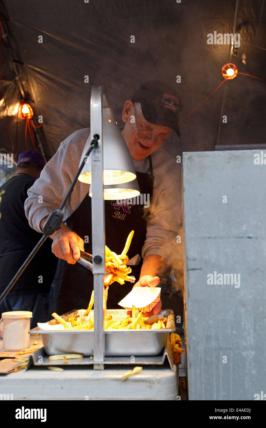 Elderly man serving French fries Stock Photo - Alamy