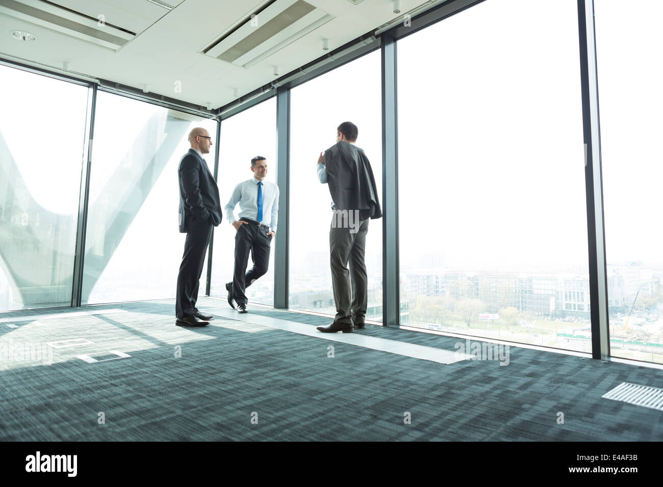 Three businessmen in office Stock Photo - Alamy