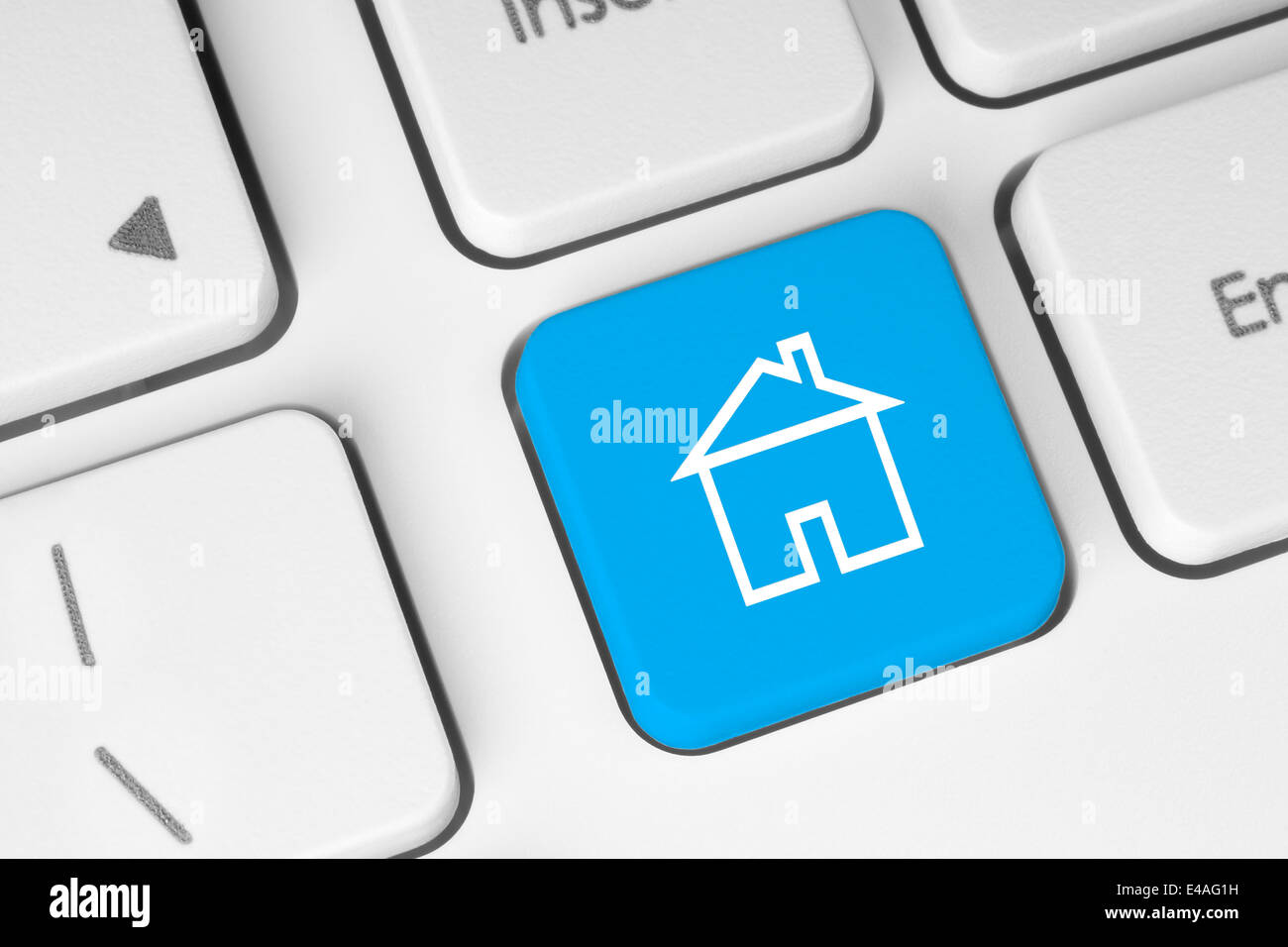 Blue button with house on computer keyboard background Stock Photo - Alamy